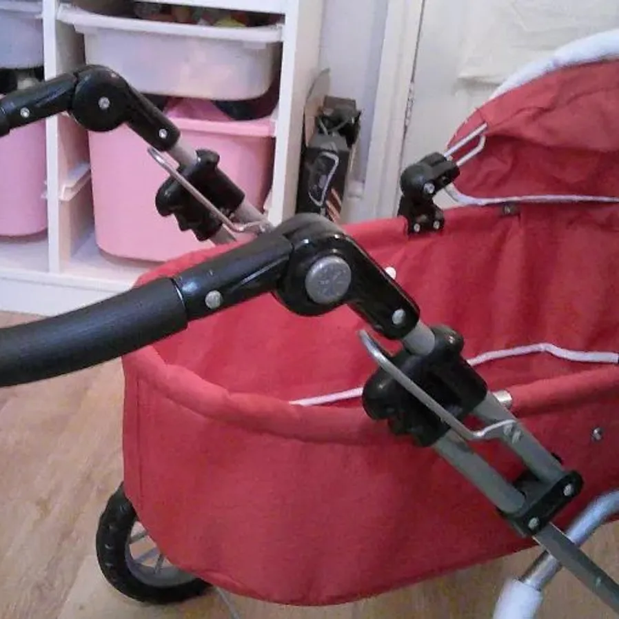 Red Silver Cross dolls pram with cover and dolls change bag. Pram has ...