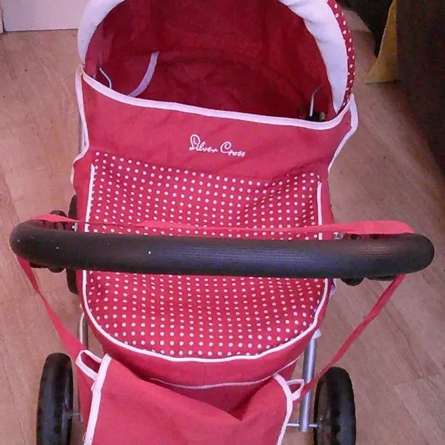 Red Silver Cross dolls pram with cover and dolls change bag. Pram has ...