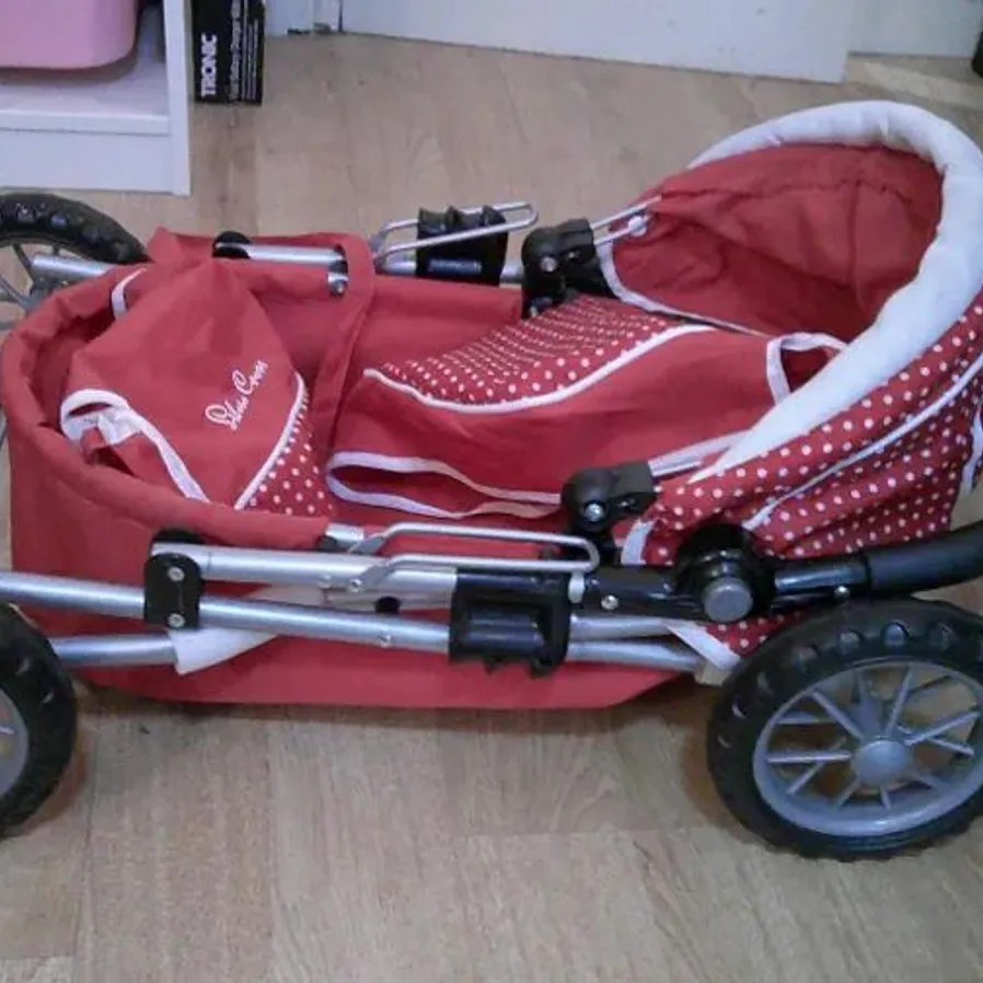 Red Silver Cross dolls pram with cover and dolls change bag. Pram has ...