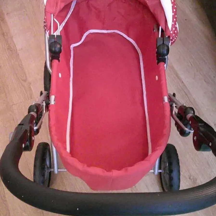 Red Silver Cross dolls pram with cover and dolls change bag. Pram has ...